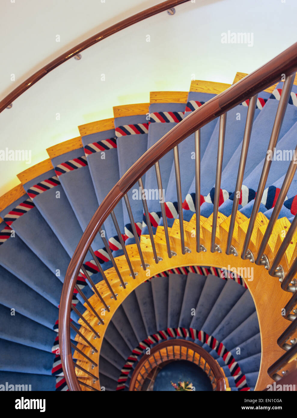 Modern spiral stairs with carpet Stock Photo - Alamy