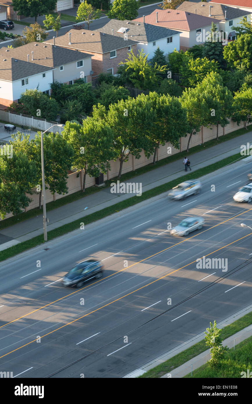 Aerial view of row of detatched homes and six lane road with paved ...