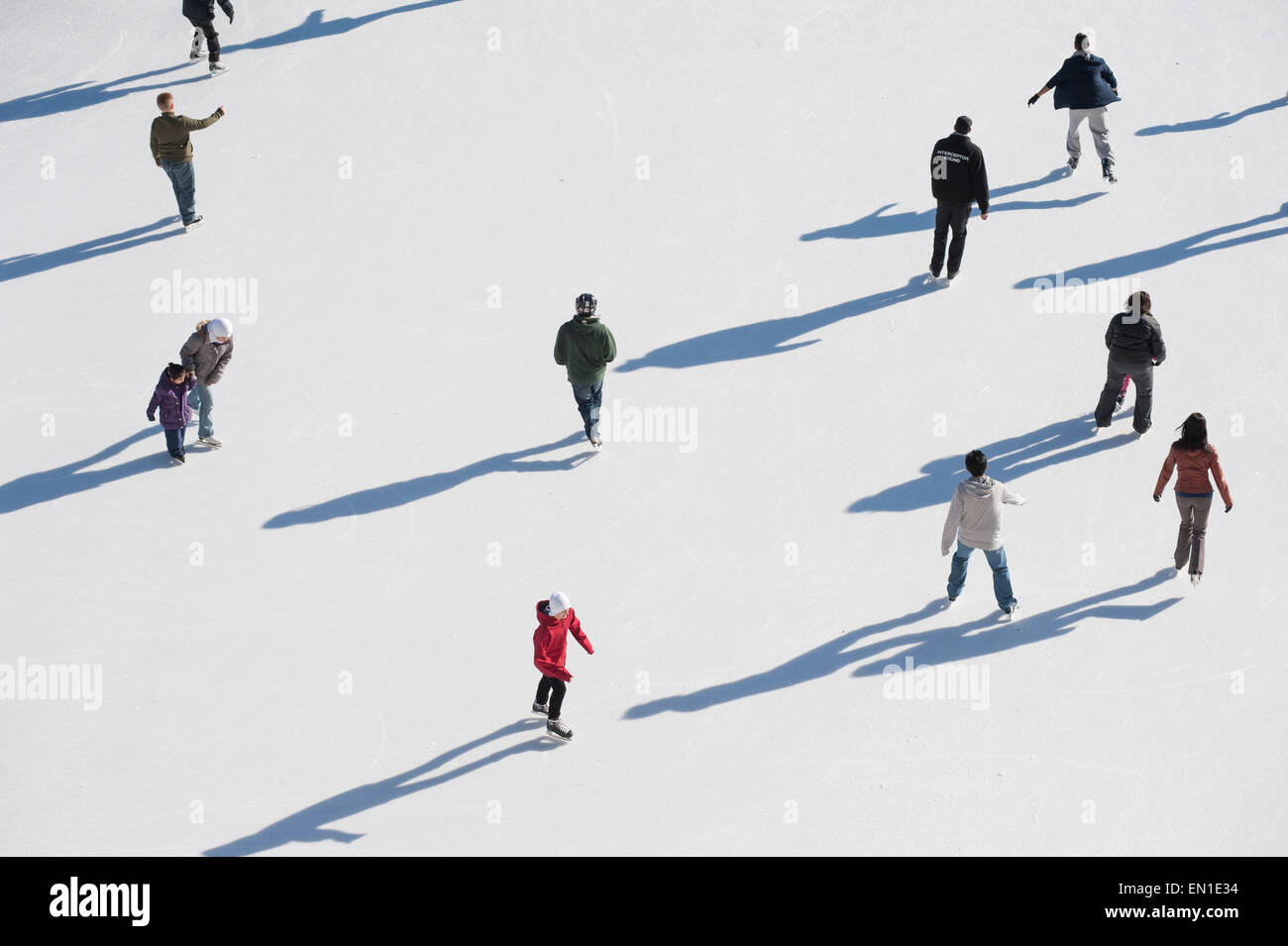 Aerial view of people skating in community rink during winter holiday ...