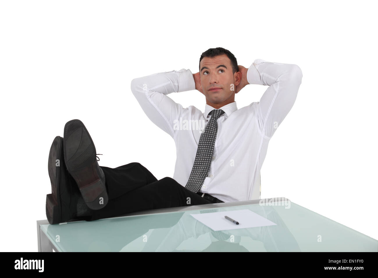 Businessman resting feet on desk Stock Photo - Alamy