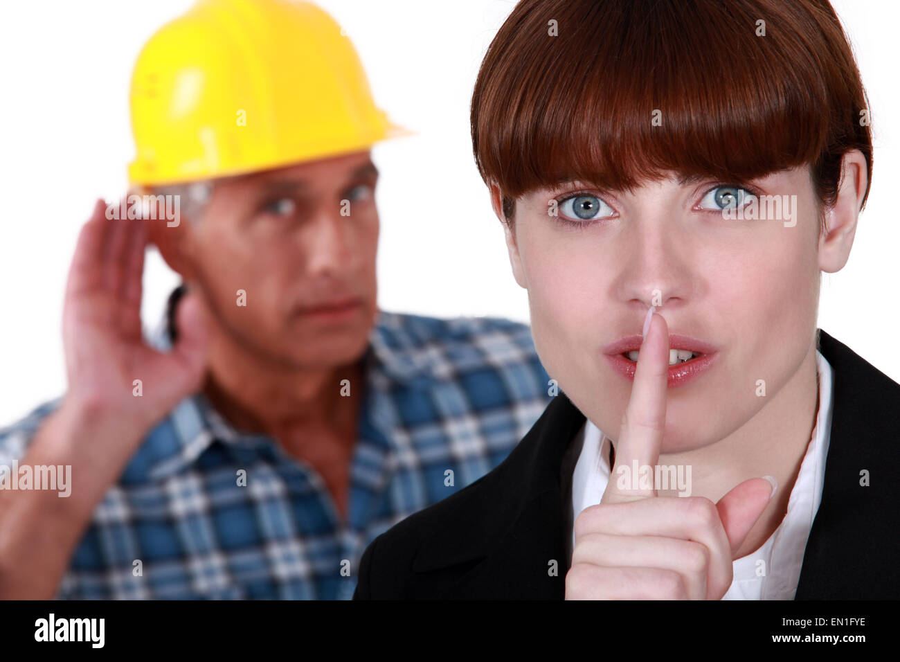 Female office worker making shush gesture Stock Photo - Alamy