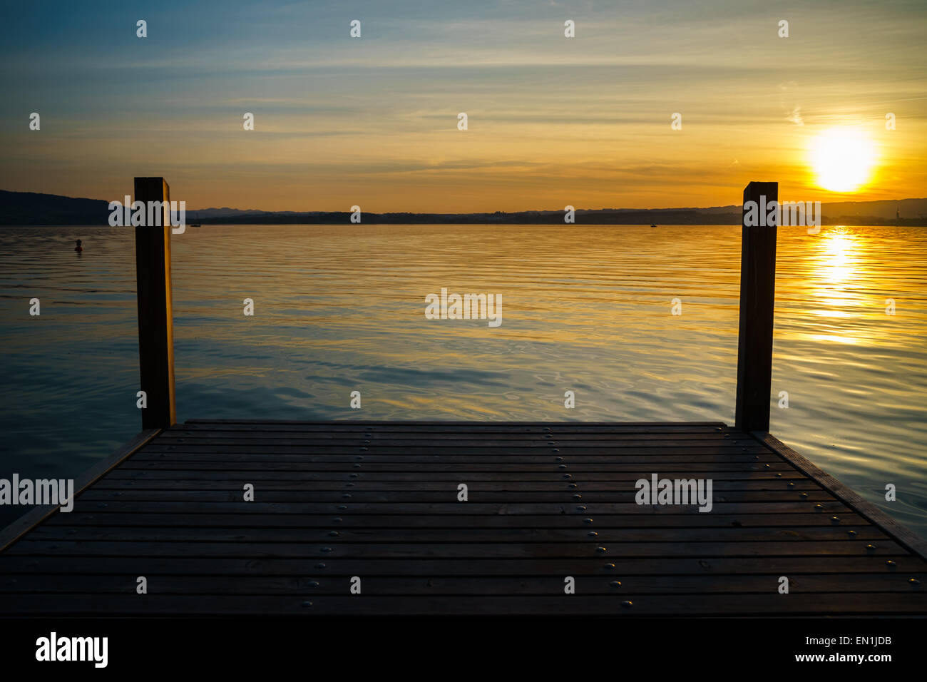 Sunset at a pier at lake Zug in Switzerland Stock Photo - Alamy