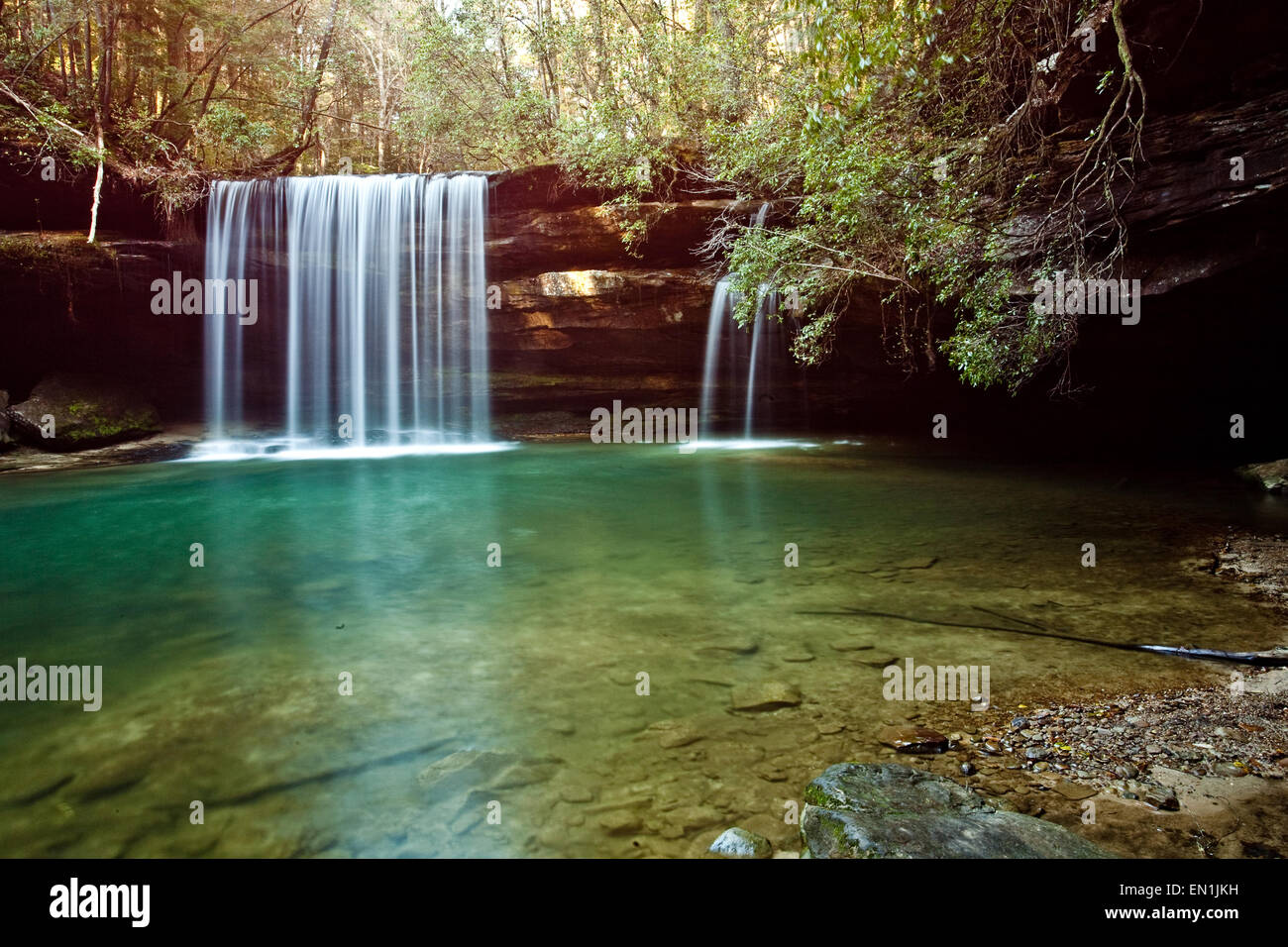 Waterfall flowing through the forest Stock Photo - Alamy Waterfall flowing through the forest Stock Photo - Alamy