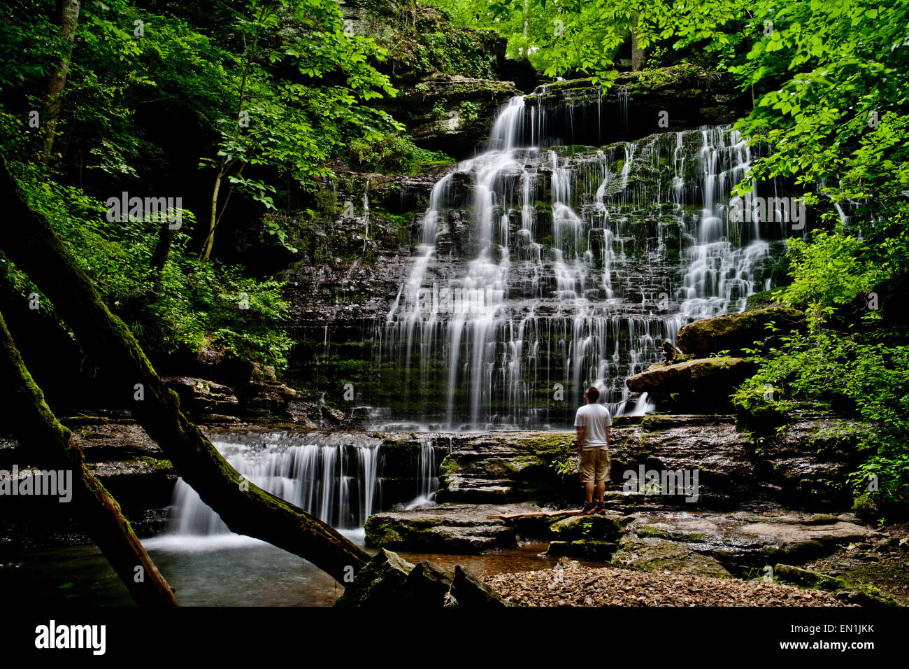 Man looking at water fall Stock Photo - Alamy