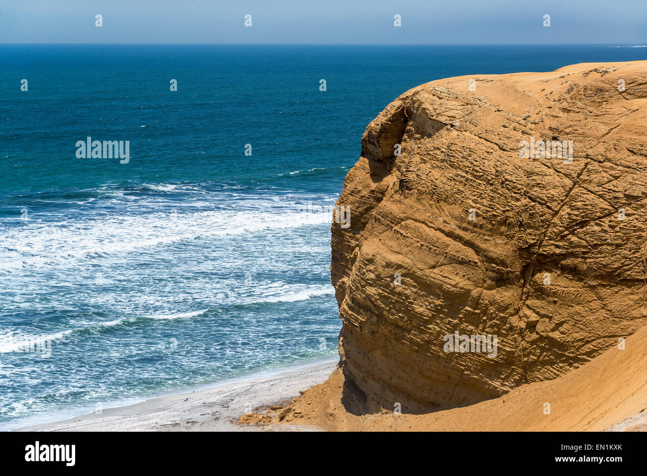 Dry barren desert rock with Pacific Ocean in the background in Paracas ...