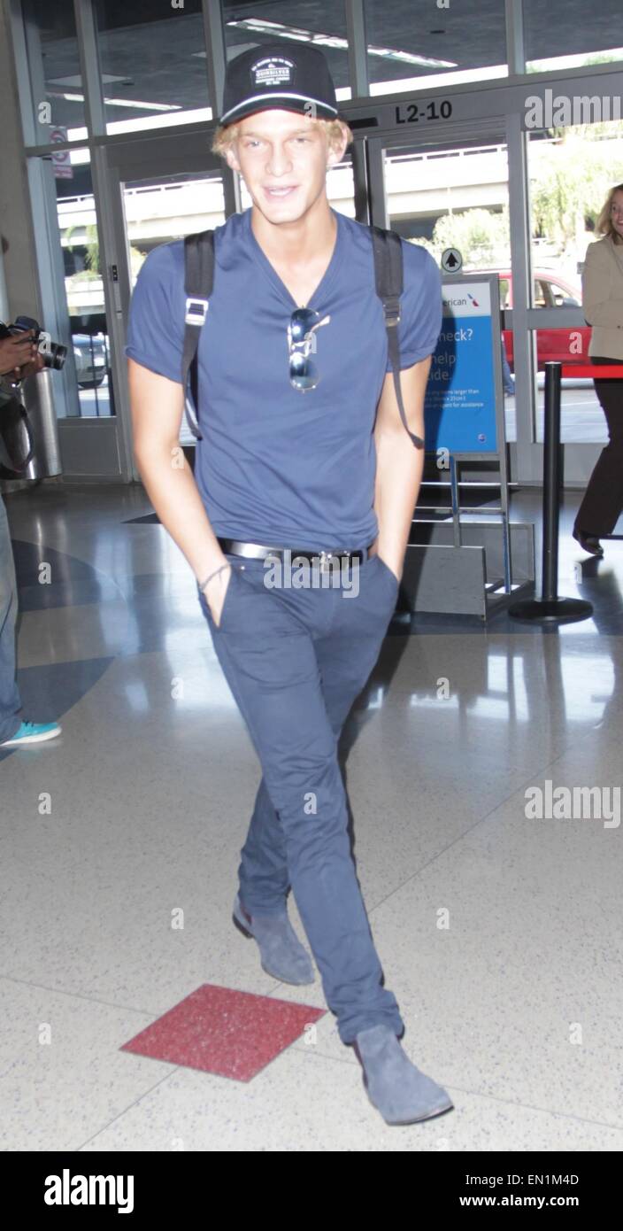 Australian pop singer, Cody Simpson dressed in blue, walks with his ...