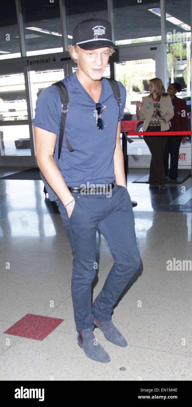 Australian pop singer, Cody Simpson dressed in blue, walks with his ...