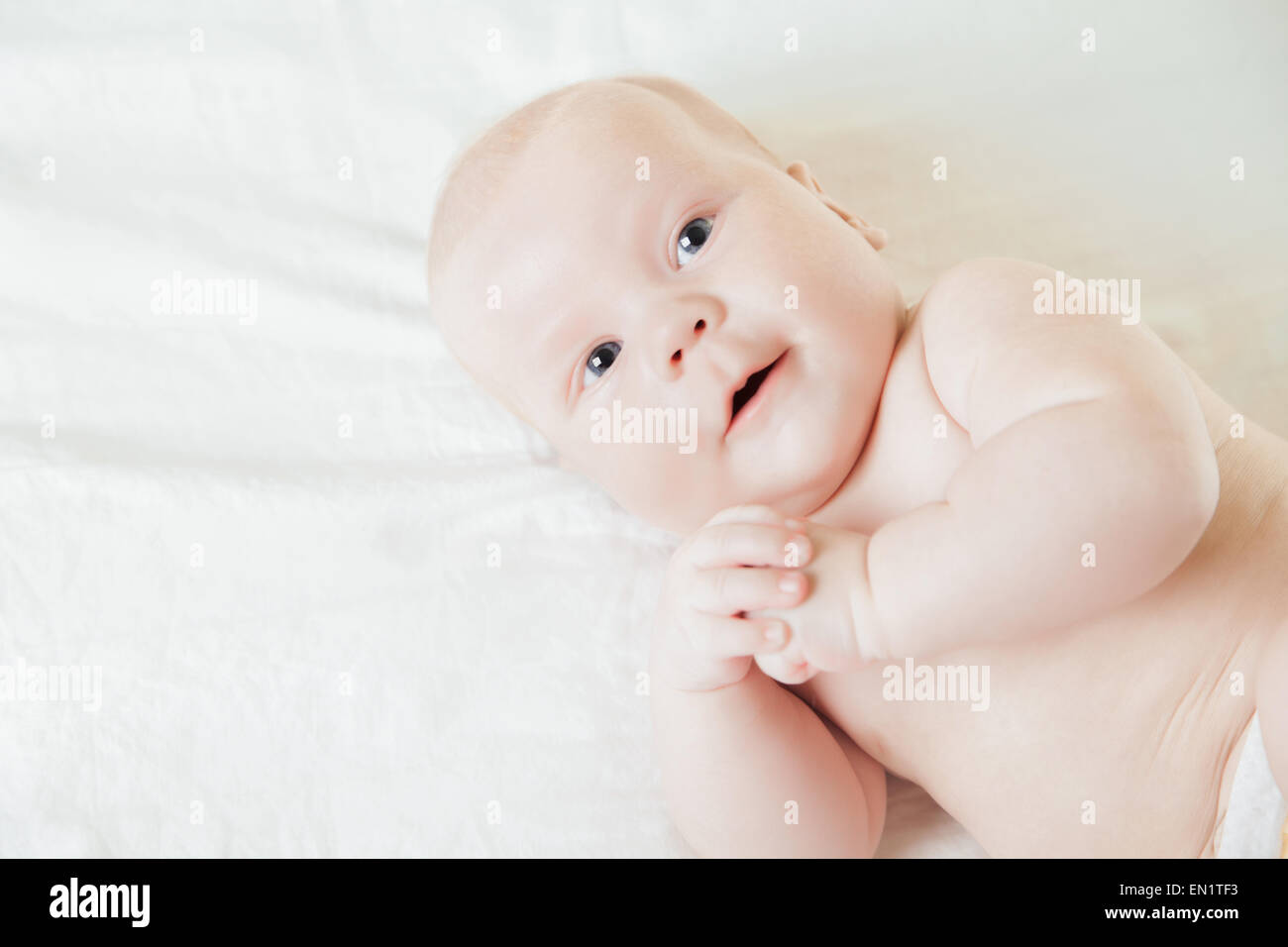 Newborn Baby Lying on Back looking aside Stock Photo - Alamy