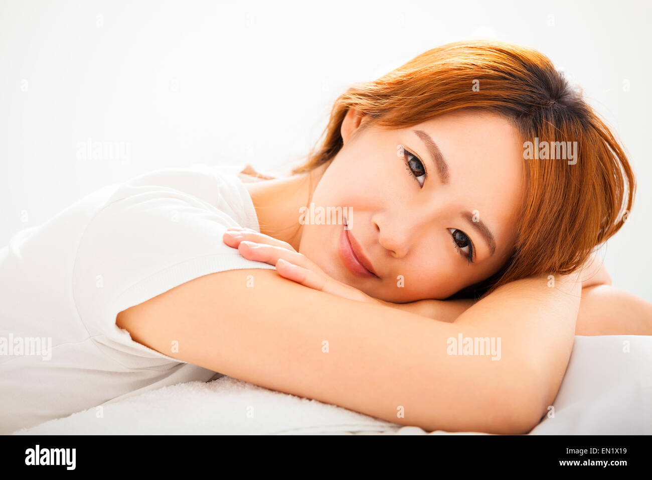 Attractive young beautiful Woman Waking Up In Bed Stock Photo - Alamy