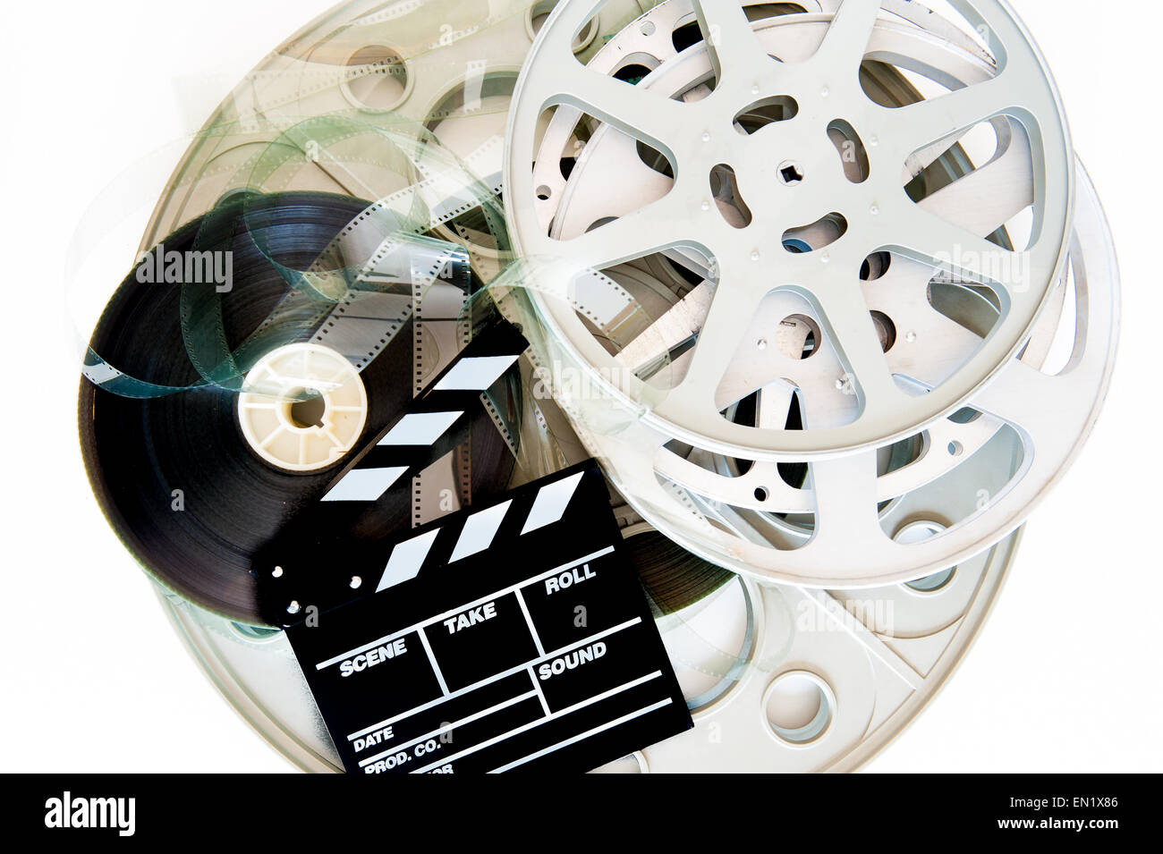 Stack of different movie film reels with clapper board on white ...