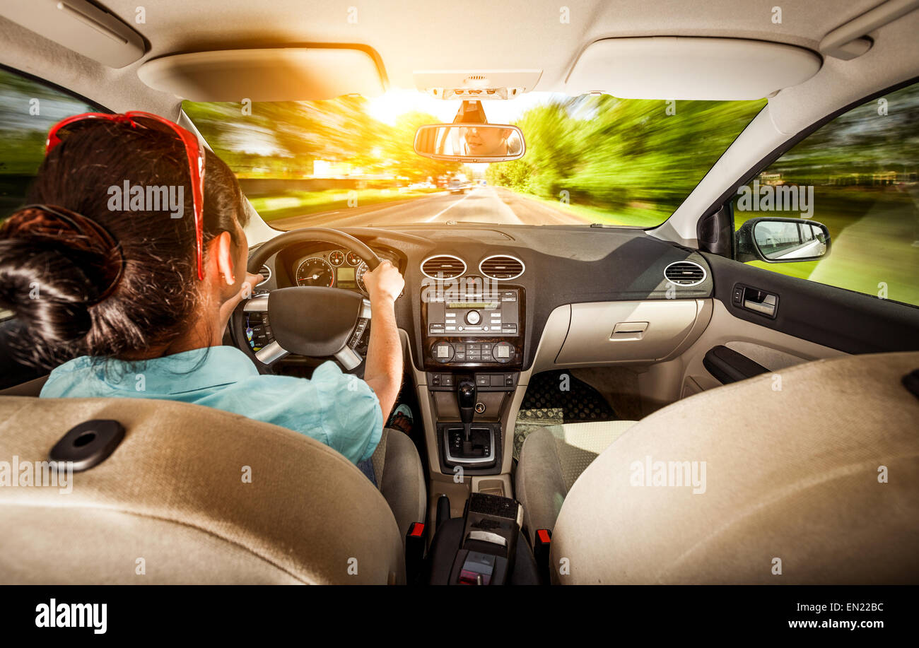 Woman rides on the car at high speed Stock Photo - Alamy
