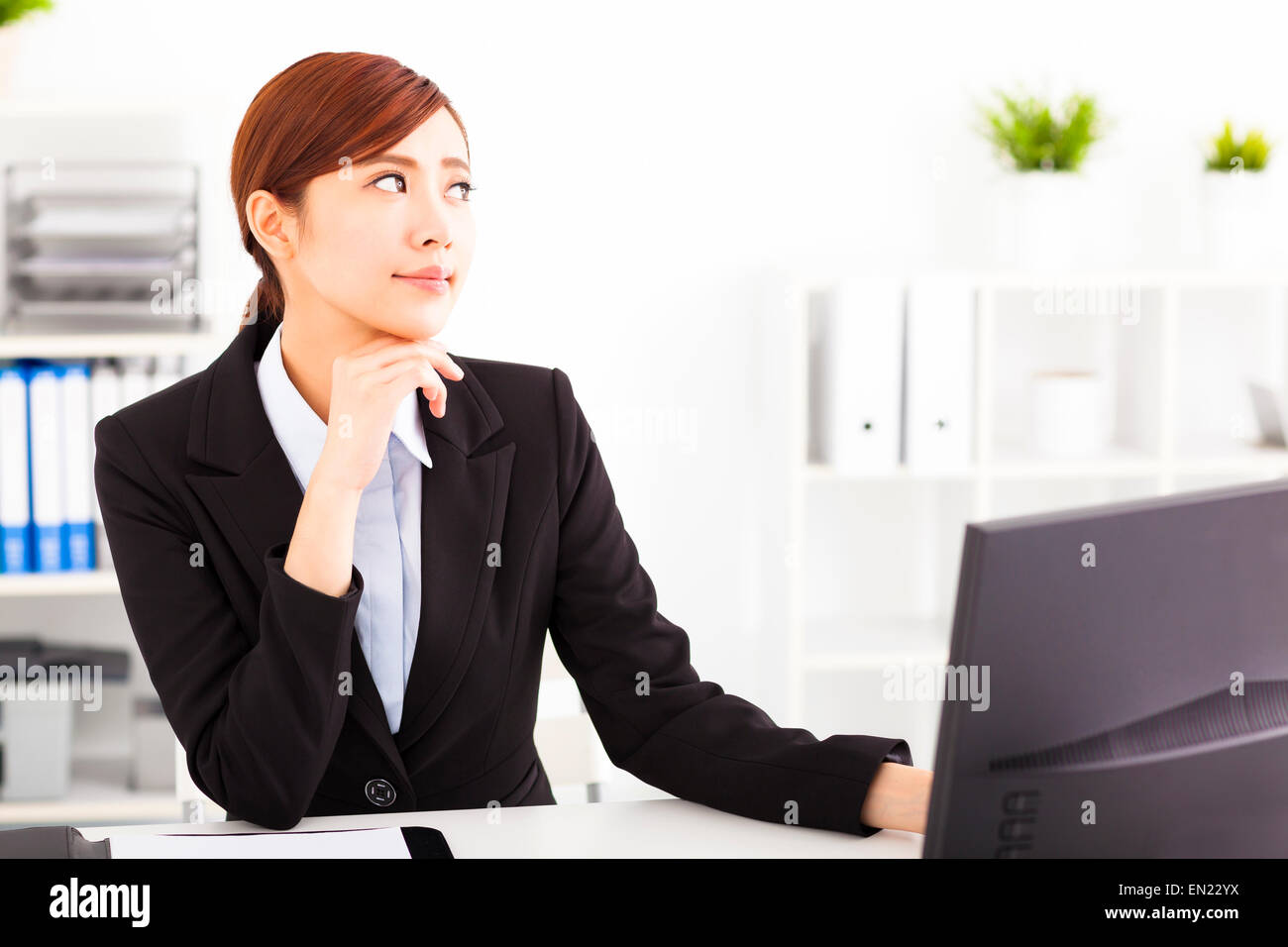young business woman thinking in the office Stock Photo - Alamy