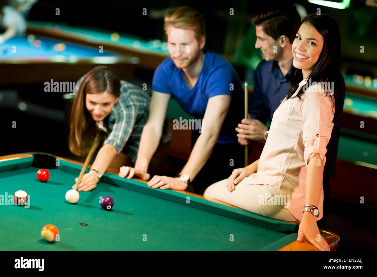 Young people playing pool Stock Photo - Alamy