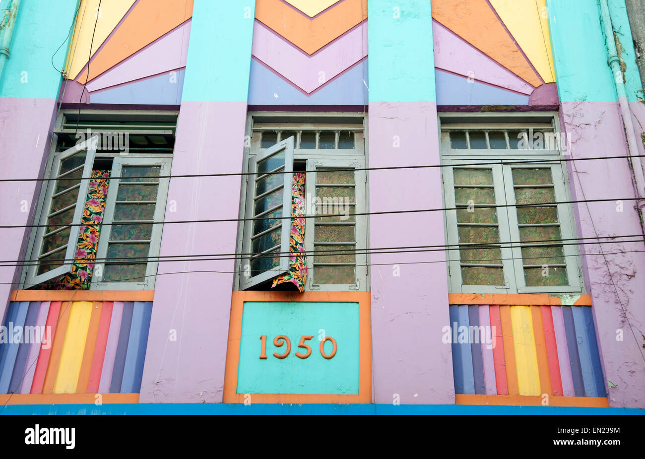 Colourful detail of windows and rainbow painted building in Yangon ...