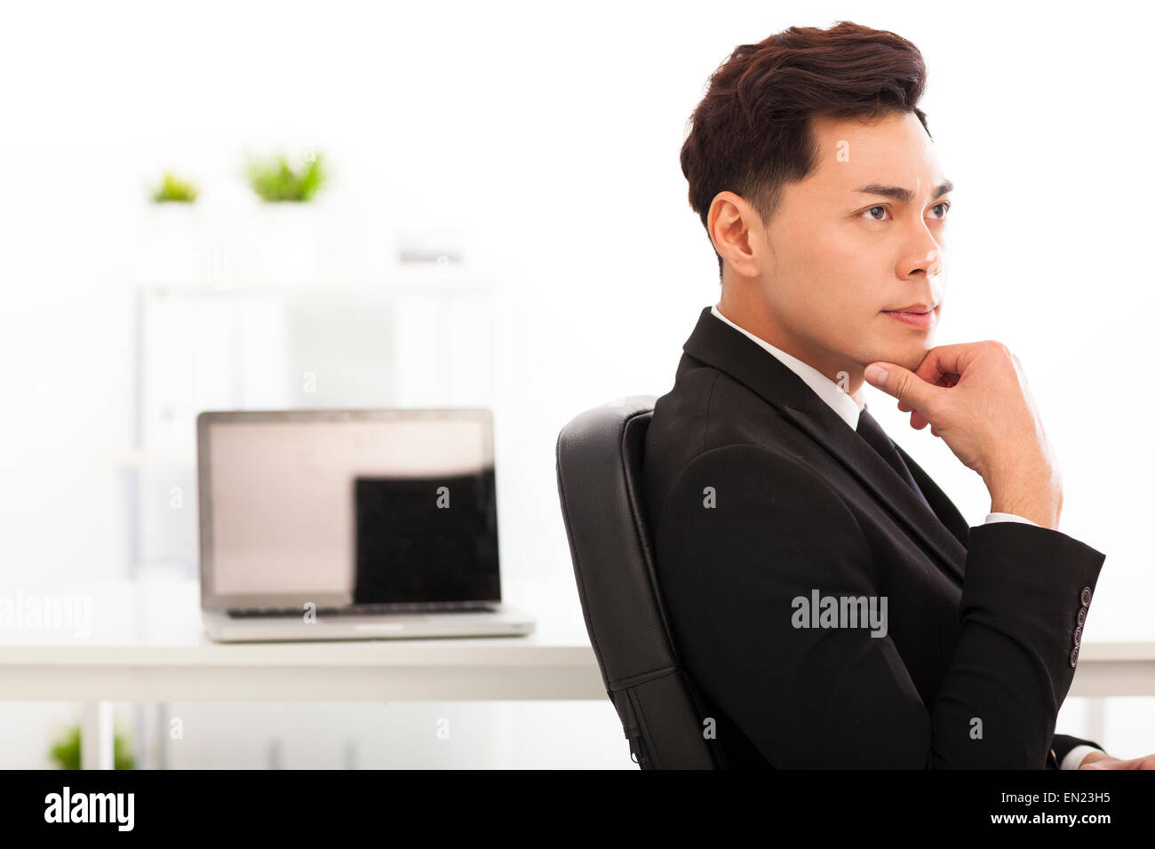 Young business man thinking in the office Stock Photo - Alamy