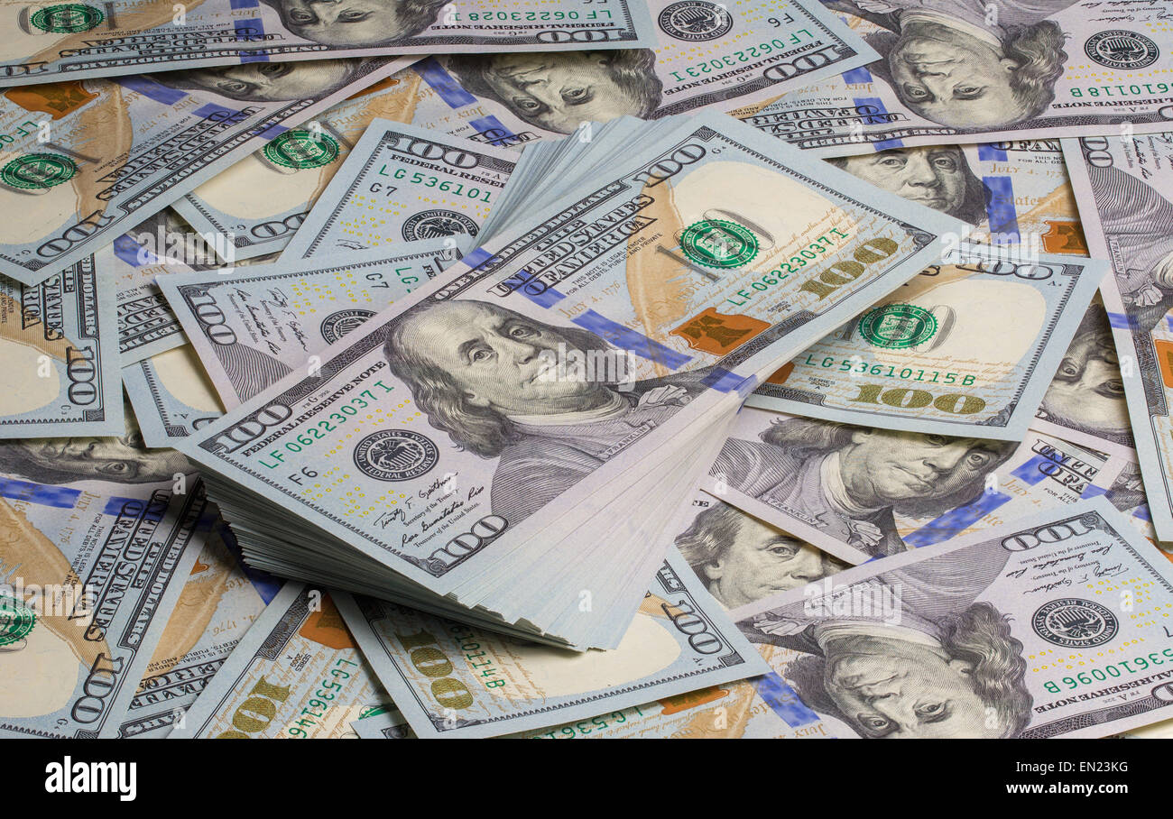 Bundle of dollars banknotes on 100 dollars background Stock Photo - Alamy