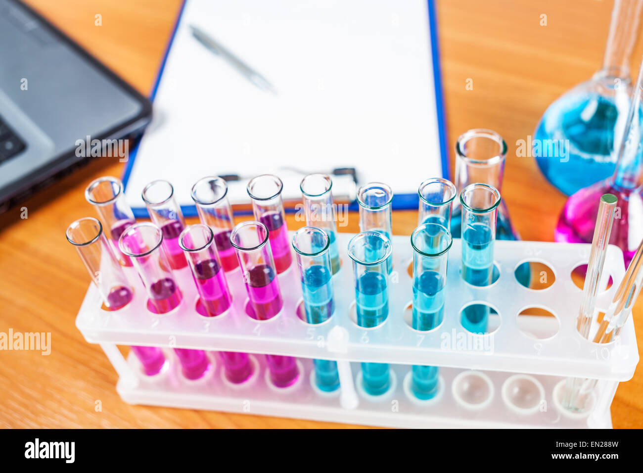 test tubes and flasks with reagents closeup on wooden background Stock ...