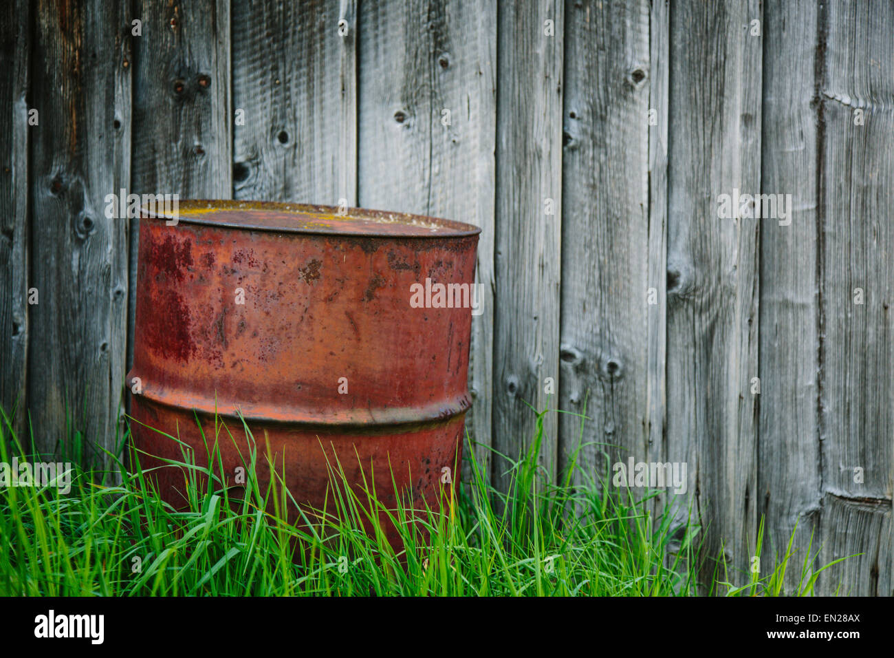 Old rusty barrel in front of an old cottage Stock Photo - Alamy