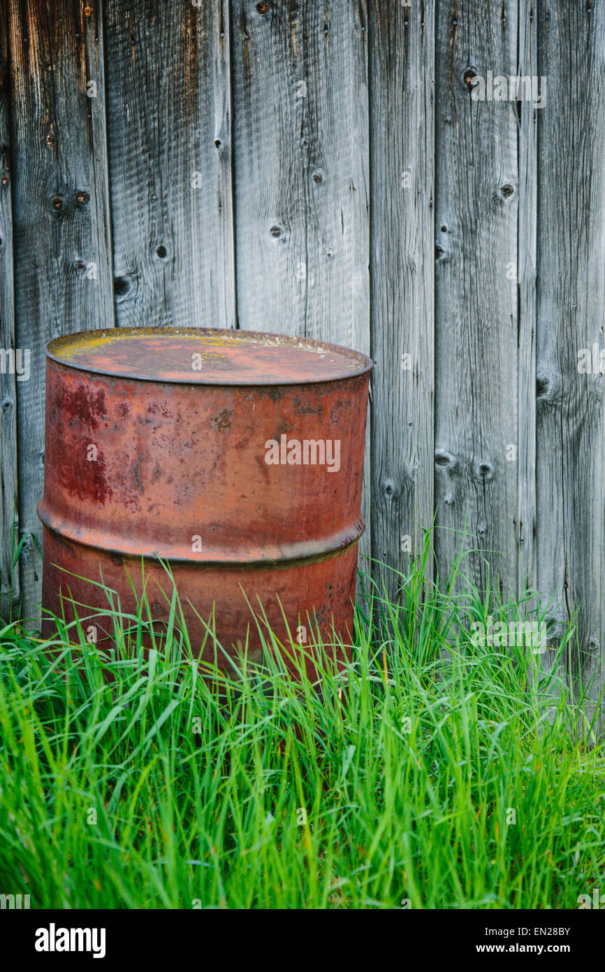 Old rusty barrel in front of an old cottage Stock Photo - Alamy
