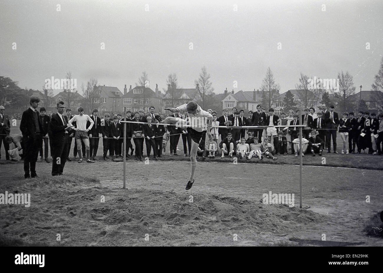 1960s historical, a school sports day, pupil attempting the high jump ...