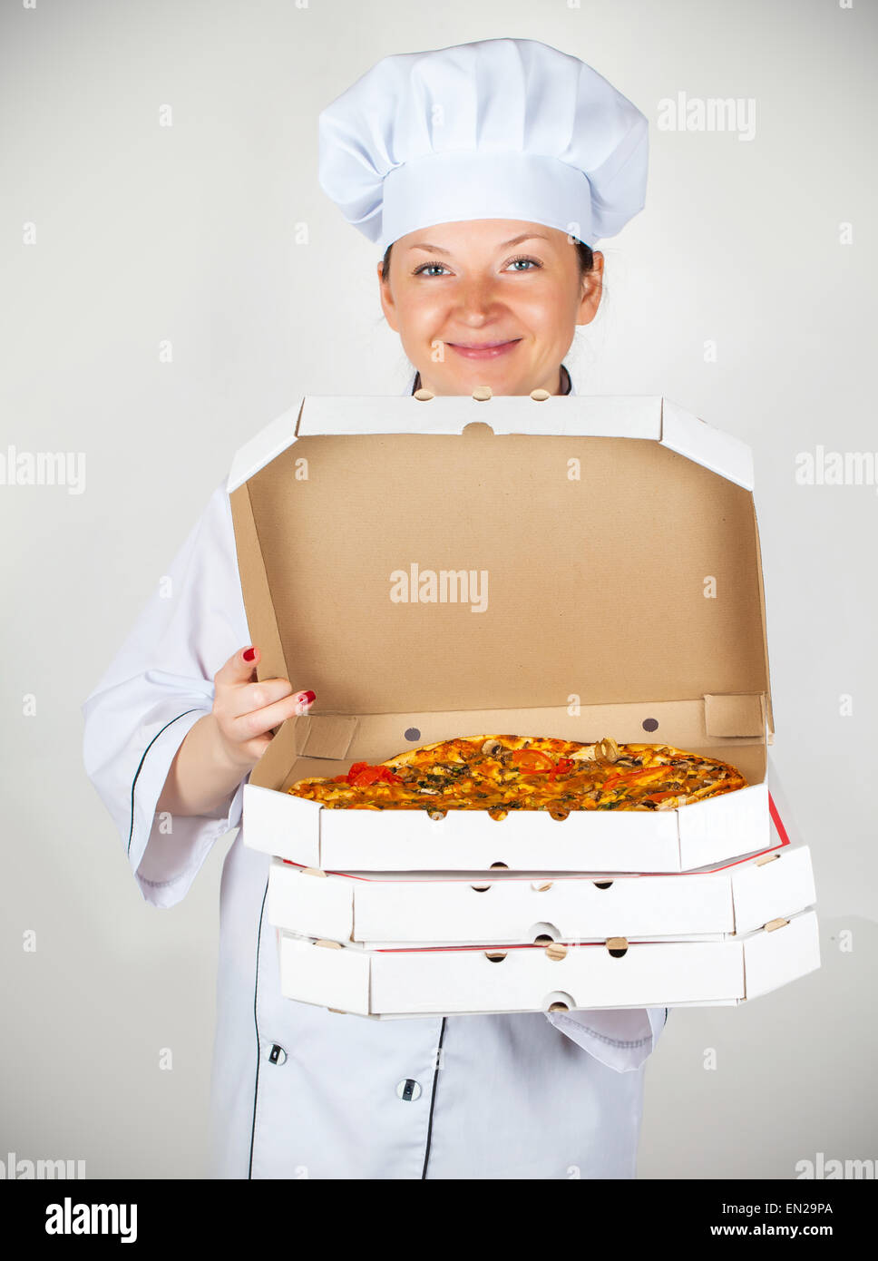 cook with a pizza in box on a light background Stock Photo - Alamy