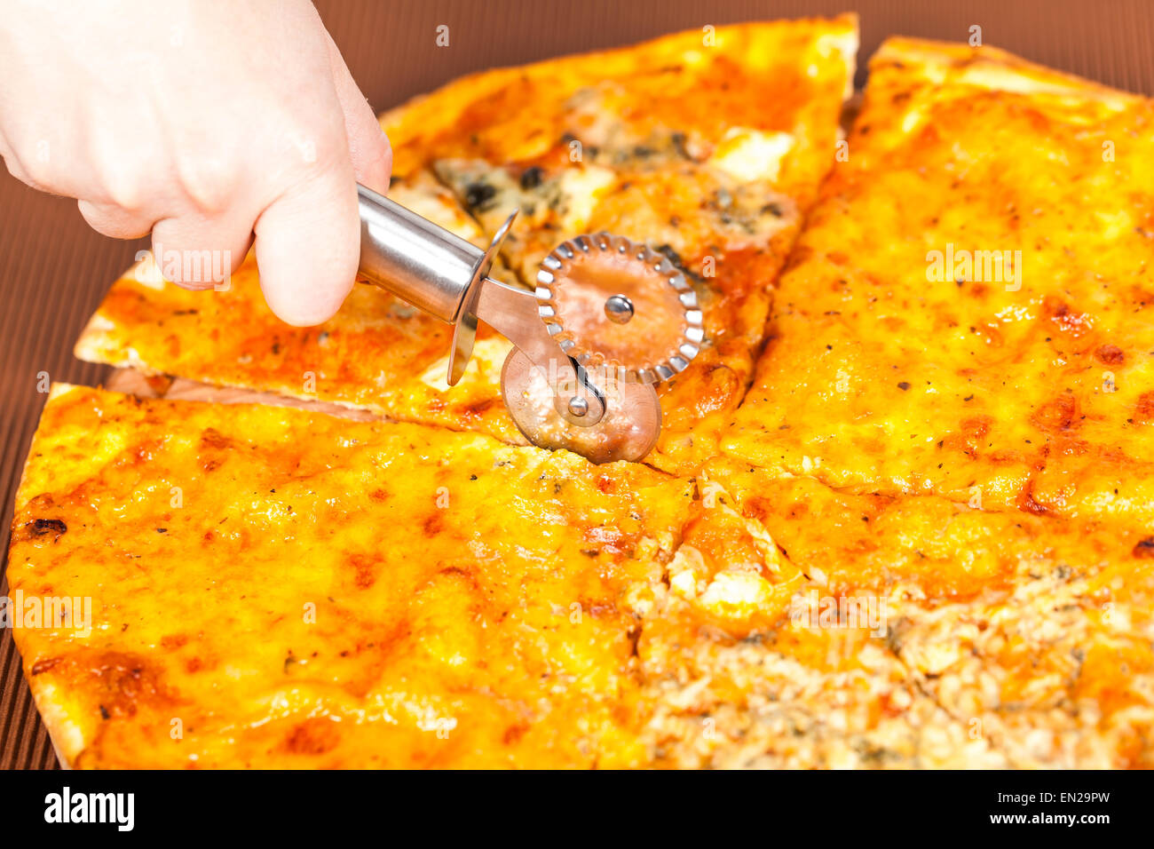 Italian cuisine cook cuts pizza hi-res stock photography and images - Alamy