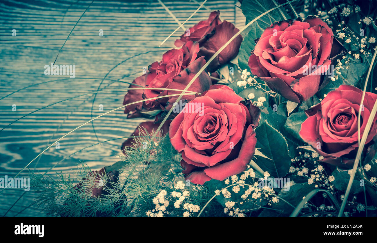 Beautiful red roses bouquet against wooden background Stock Photo - Alamy
