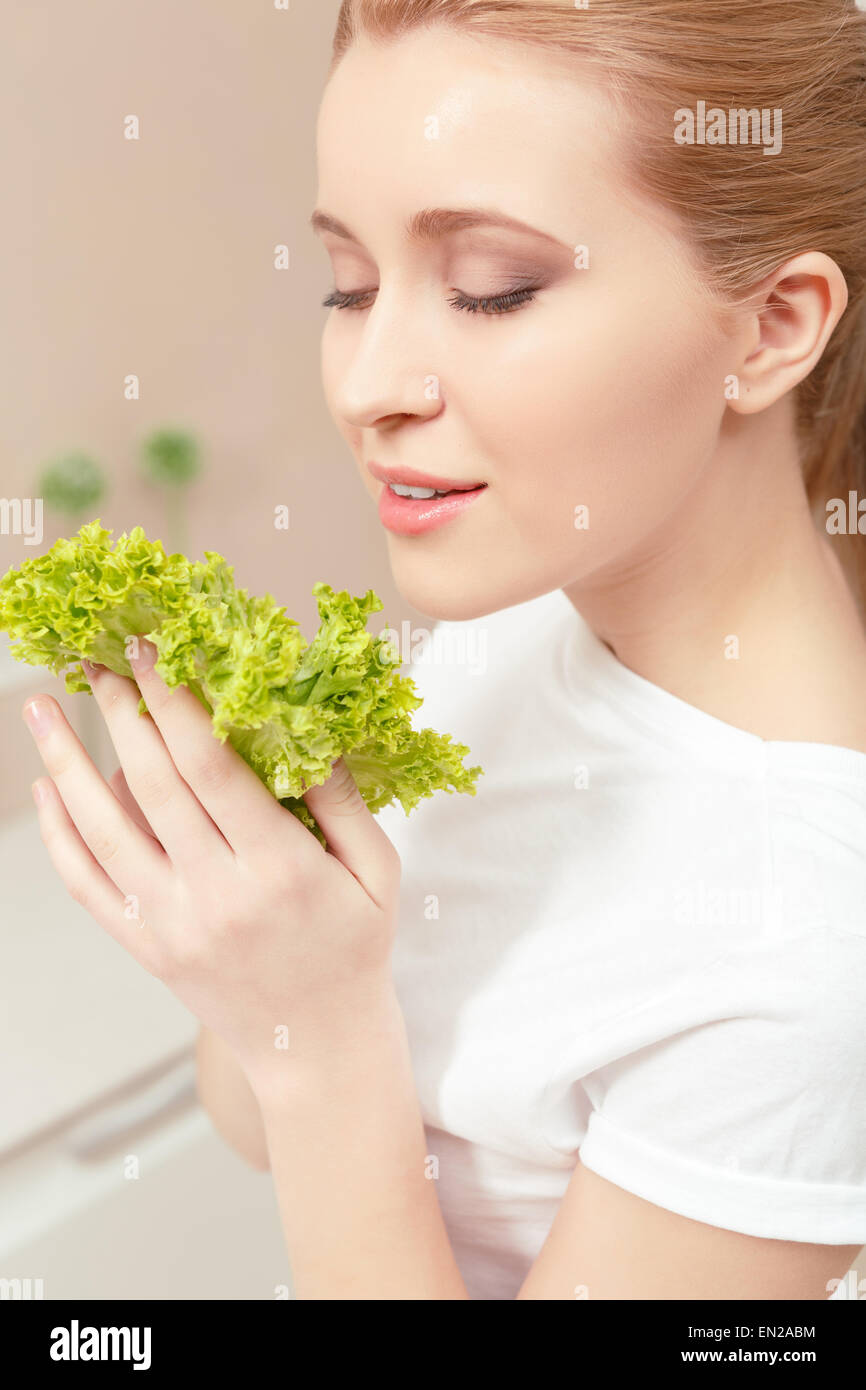 Lady smiles while looking at salad Stock Photo - Alamy