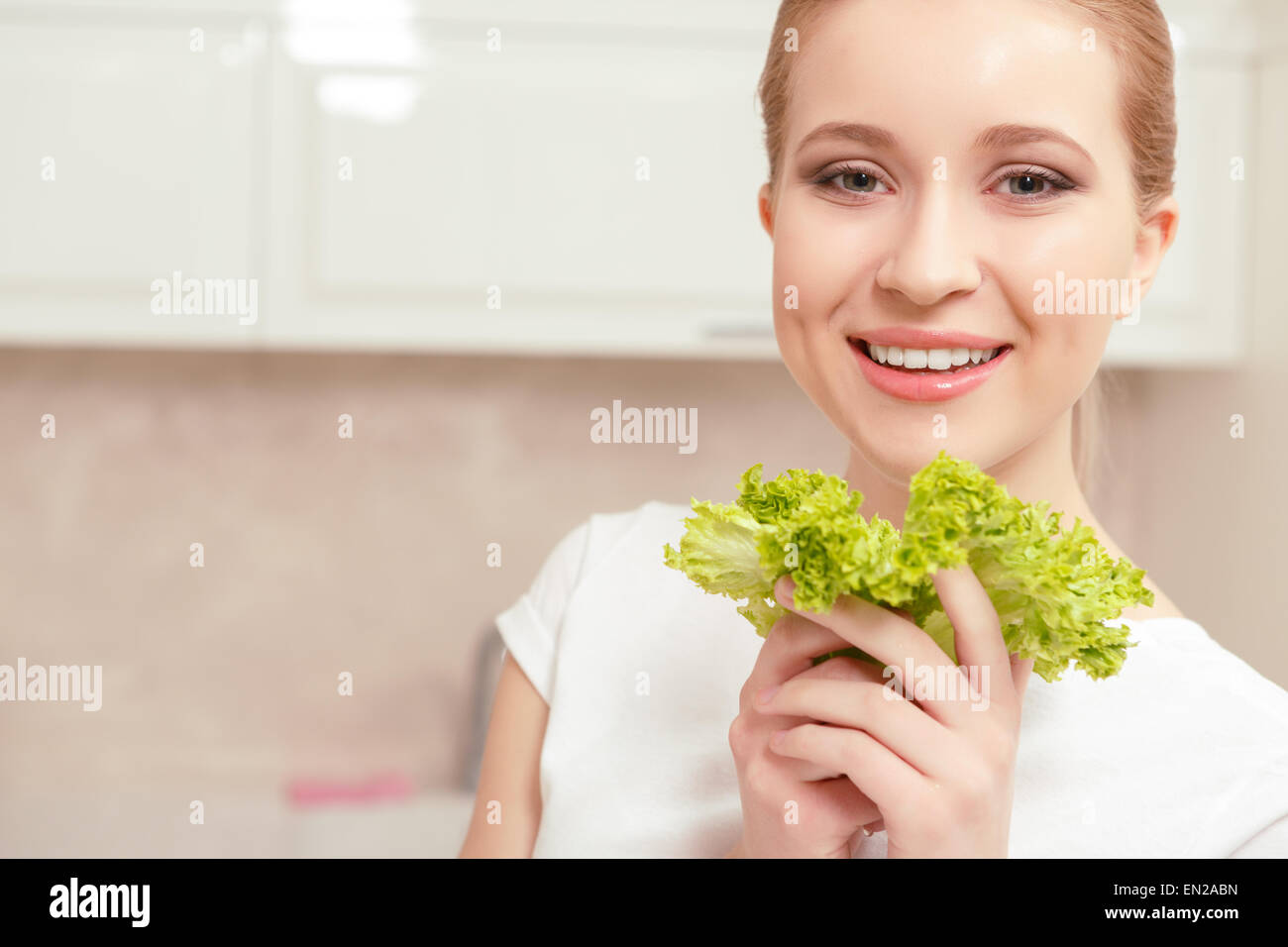 Lady smiles while holding salad Stock Photo - Alamy