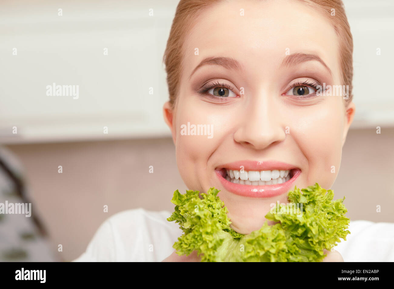Lady smiles while holding salad Stock Photo - Alamy