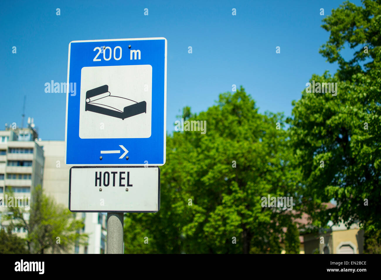 Blue hotel direction and distance road sign Stock Photo - Alamy