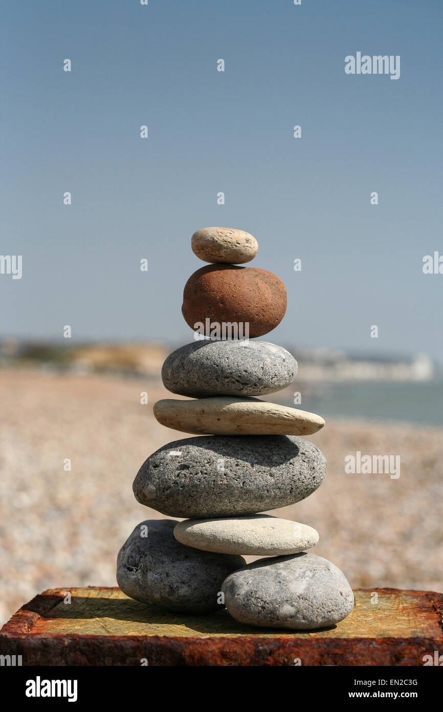 A stack of pebbles against a seaside background Stock Photo - Alamy