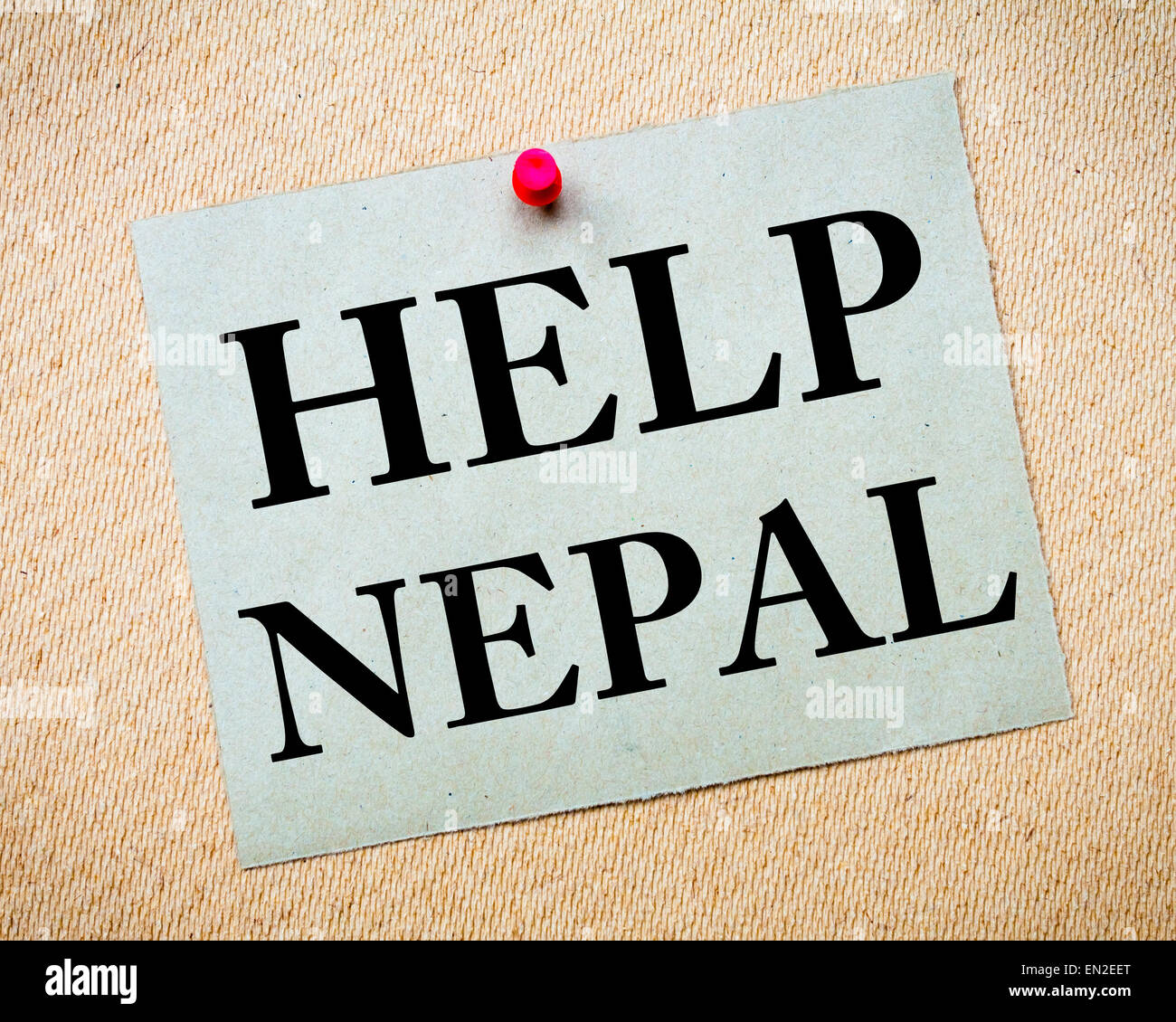 HELP NEPAL Note. Recycled paper note pinned on cork board. Concept ...