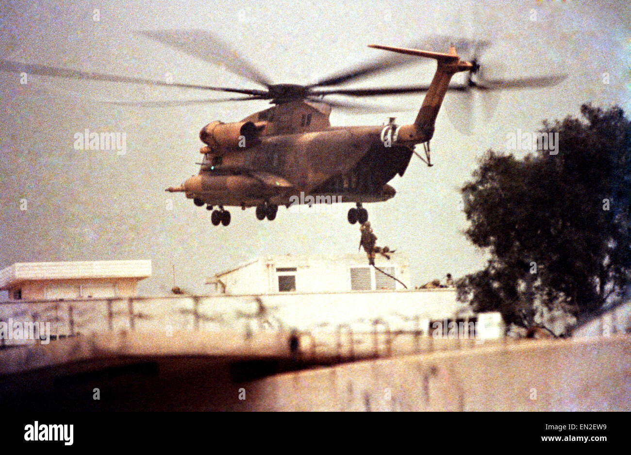 US Marine Corps commandos rappel from a helicopter as they recapture ...