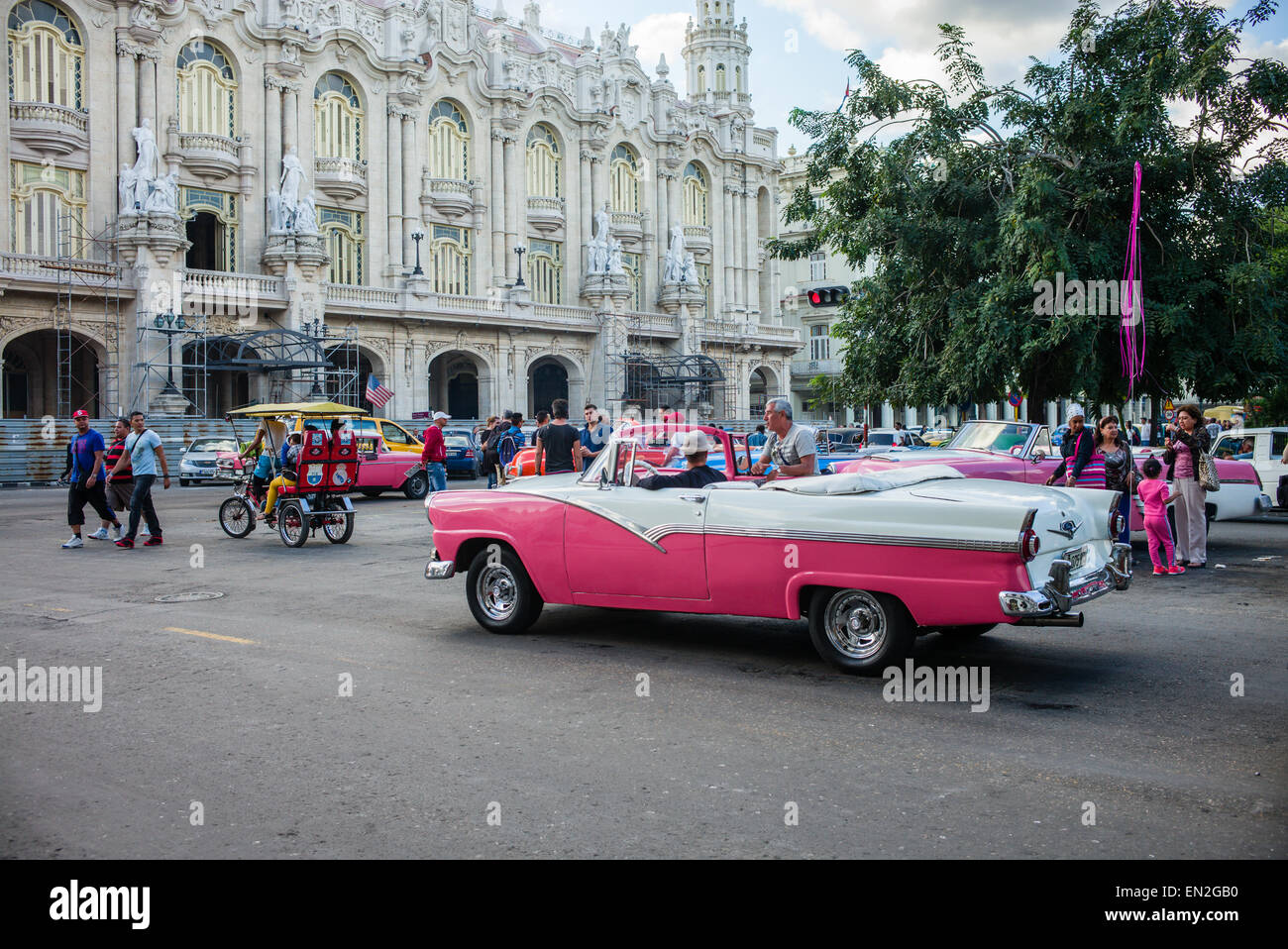 Vintage pink and white Ford convertible used as a taxi on the streets ...