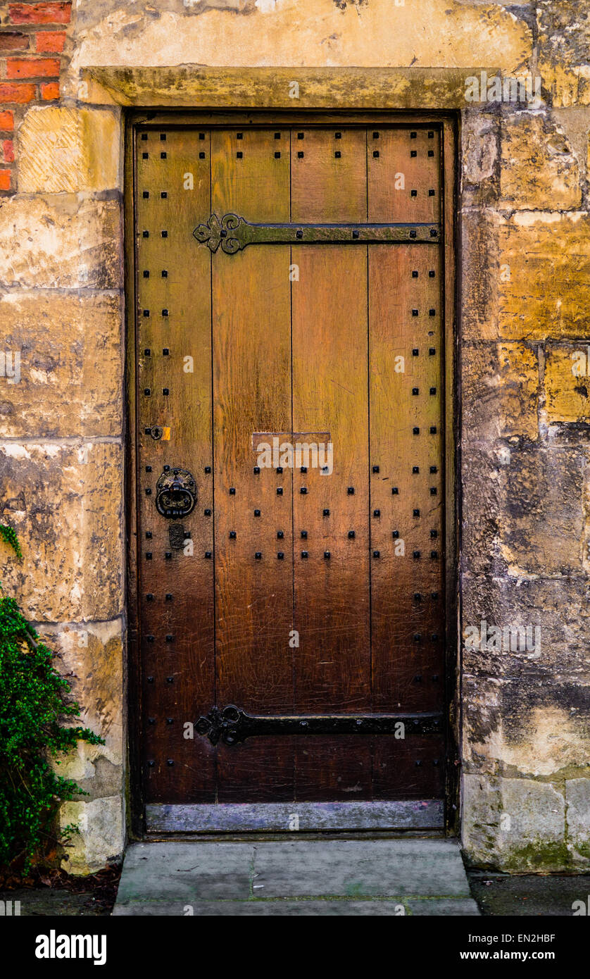 Medieval wooden door against stone block background Stock Photo - Alamy
