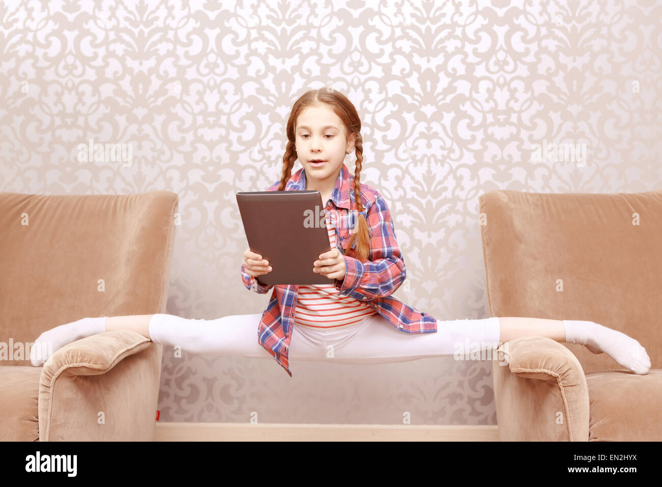 Little flexible girl splitting legs apart Stock Photo - Alamy