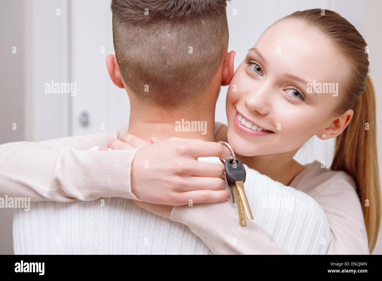 Two persons hugging with keys Stock Photo - Alamy