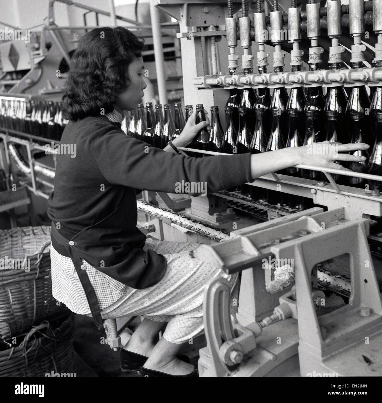 1950s historical, Hong Kong, young female operative sitting working at ...