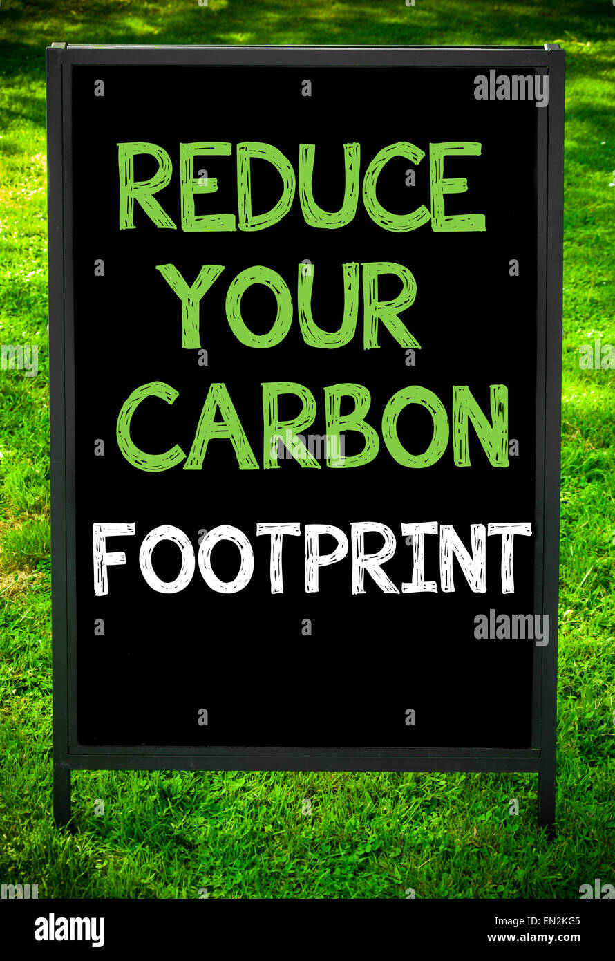 REDUCE YOUR CARBON FOOTPRINT message on sidewalk blackboard sign ...