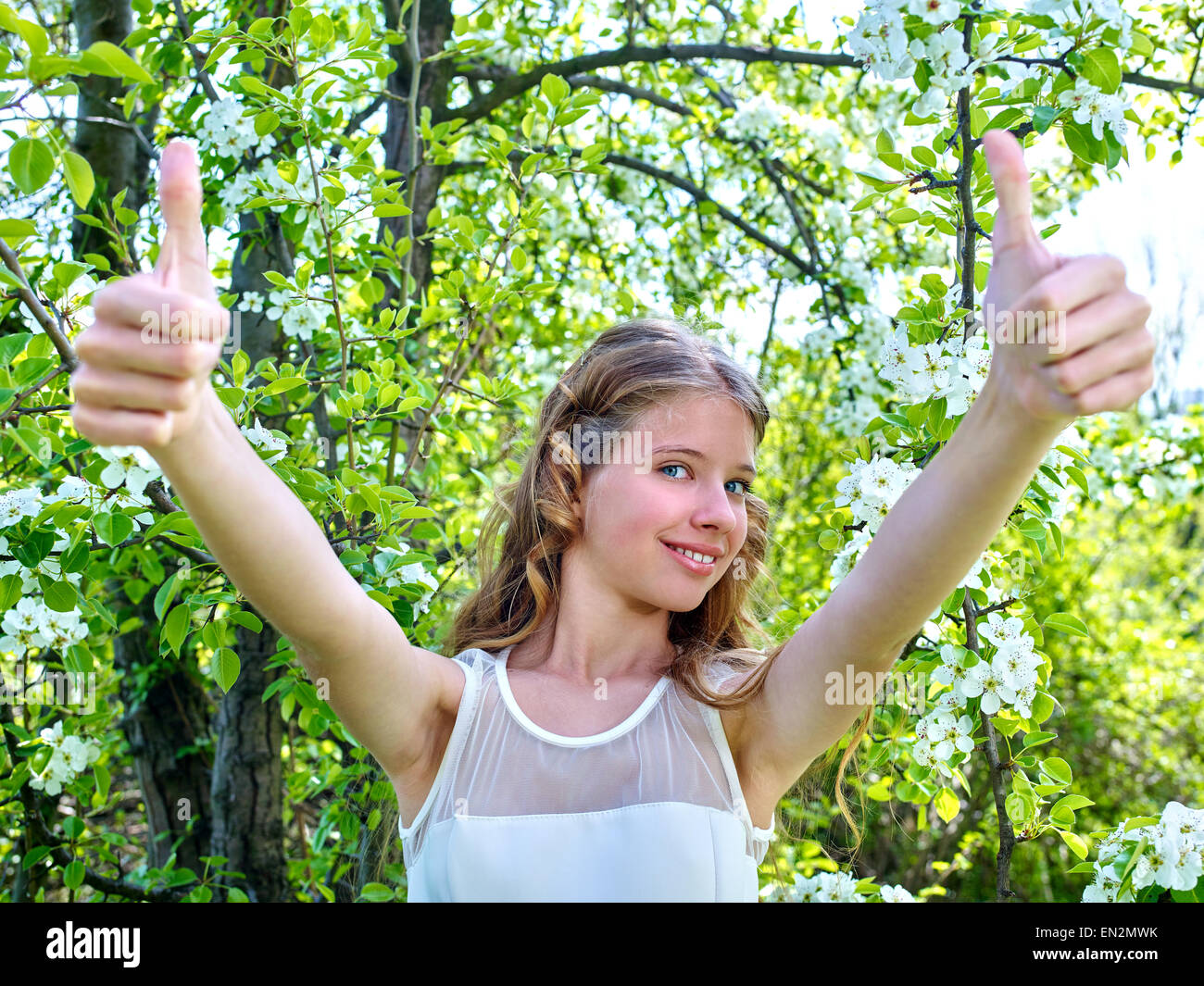 Beautiful girl with flowering tree Stock Photo - Alamy