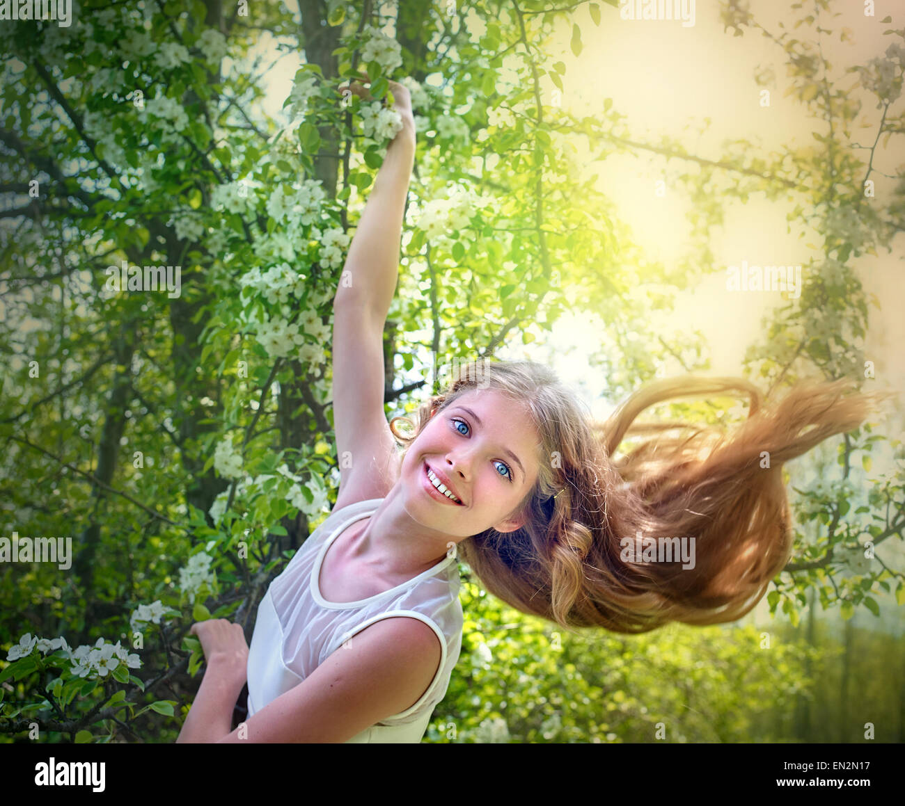 Girl in love with flowering tree Stock Photo - Alamy