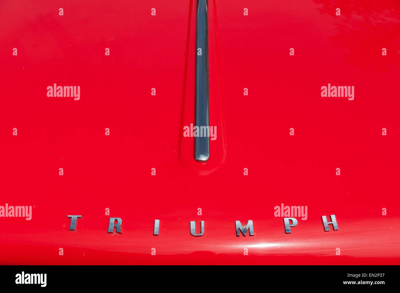 Triumph car emblem on front bonnet in red color Stock Photo - Alamy