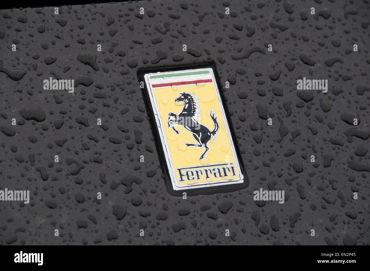 Black ferrari luxury cars badge on rear bonnet with raindrops Stock ...