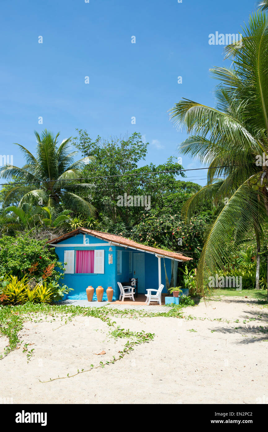 Colorful beach shack in bright blue and pink on the coast of a quiet ...