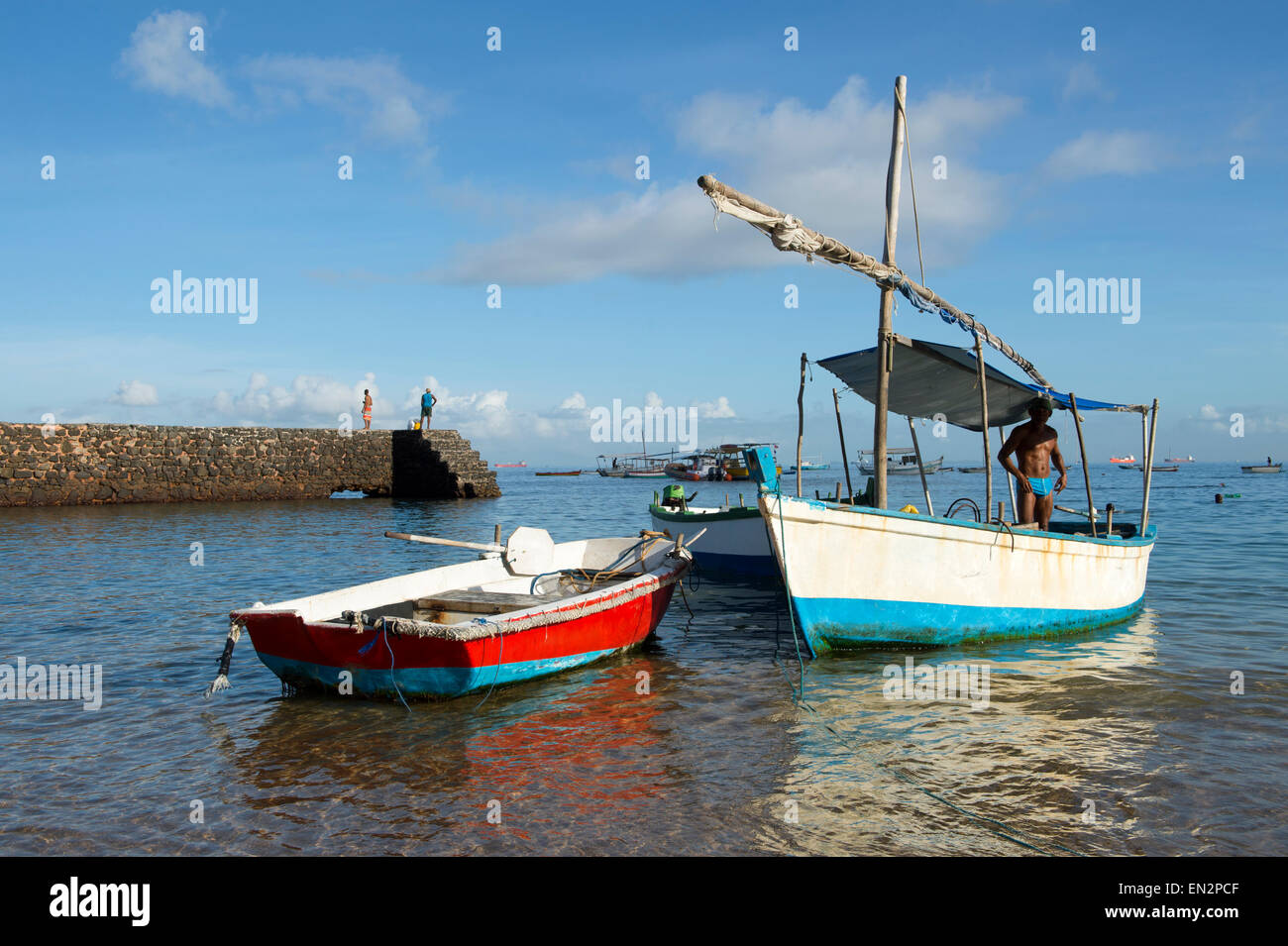 Traditional colorful fishing boats sit in the harbor at Porto da Barra ...