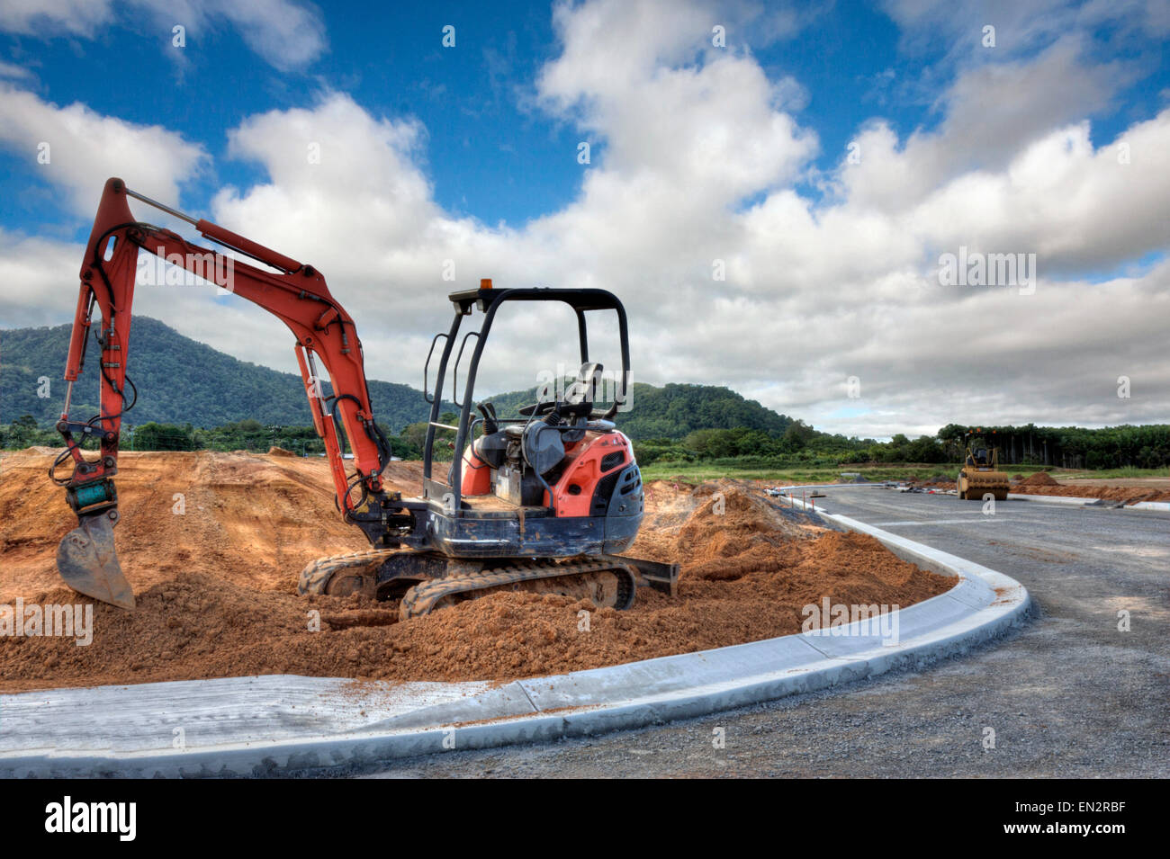 a digger in a new development area constructing road Stock Photo - Alamy