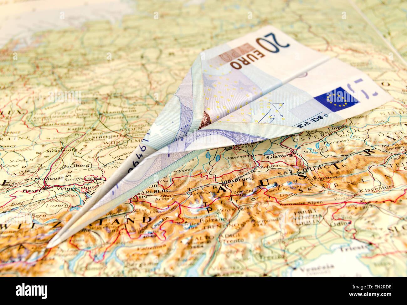 Euro note paper aeroplane over a map of Europe Stock Photo - Alamy