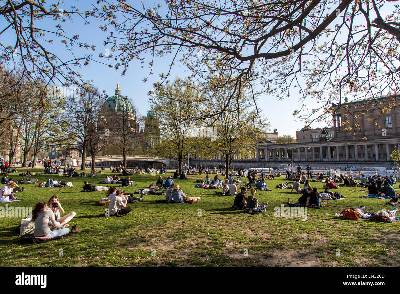 James Simon Park, along river Spree, people enjoying the spring sun in ...