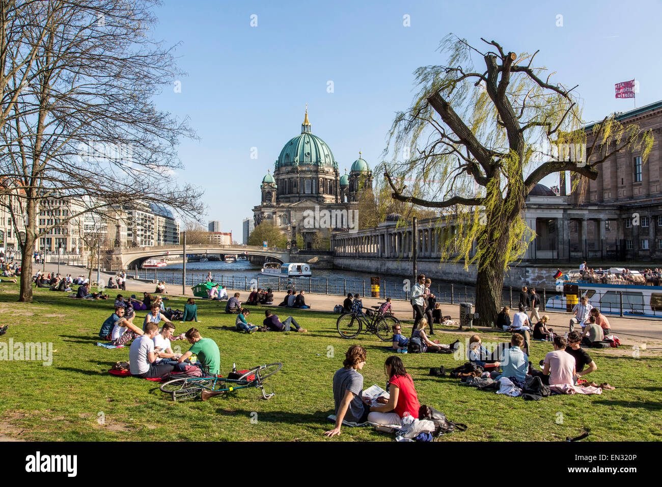 James Simon Park, along river Spree, people enjoying the spring sun in ...